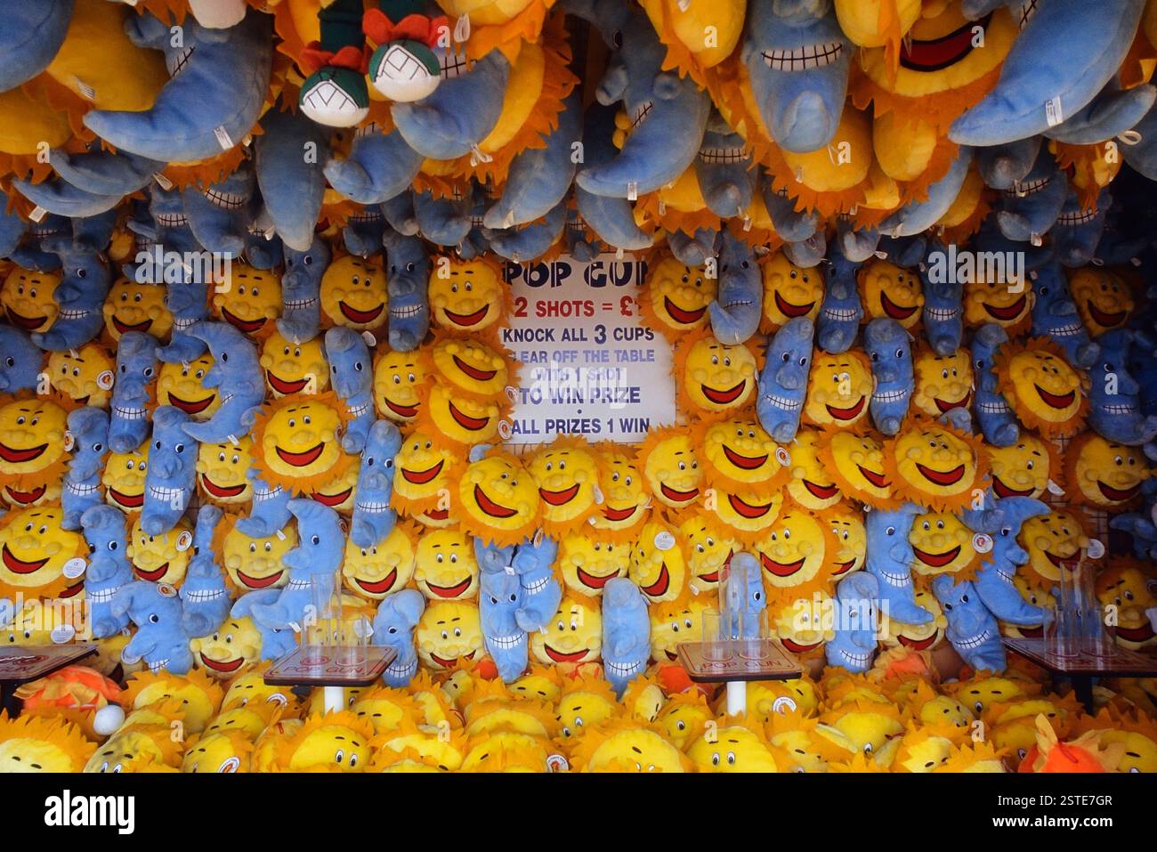 Rows of soft cuddly toy prizes on display at a arcade game stall ...