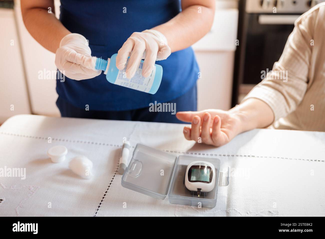 A healthcare professional is seen assisting a patient with a glucose ...