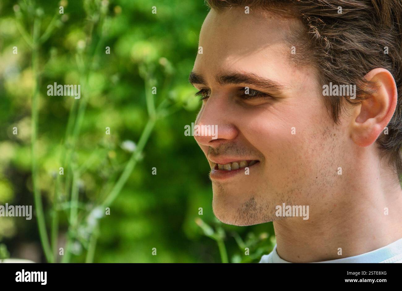 Headshot of attractive young man smiling in nature environment Stock ...
