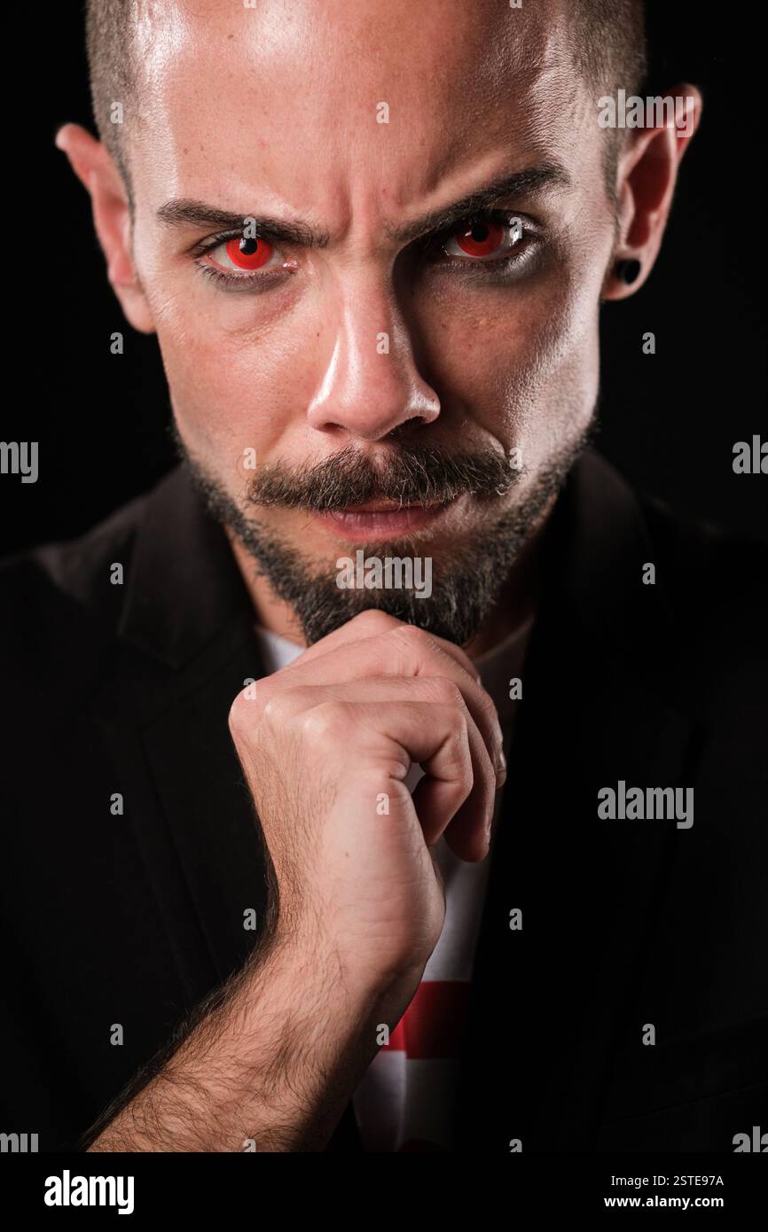 Intense portrait of a man with a stern expression, resting his chin on ...