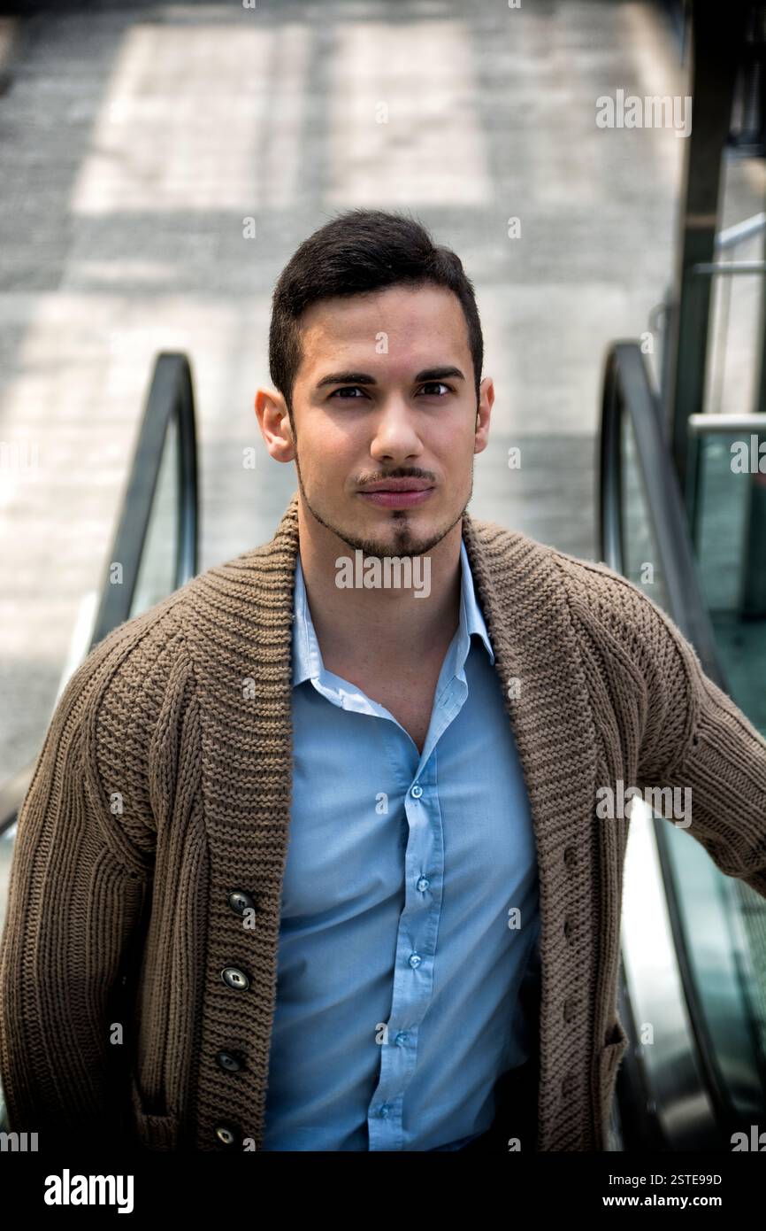 Portrait of attractive young man on escalators Stock Photo - Alamy