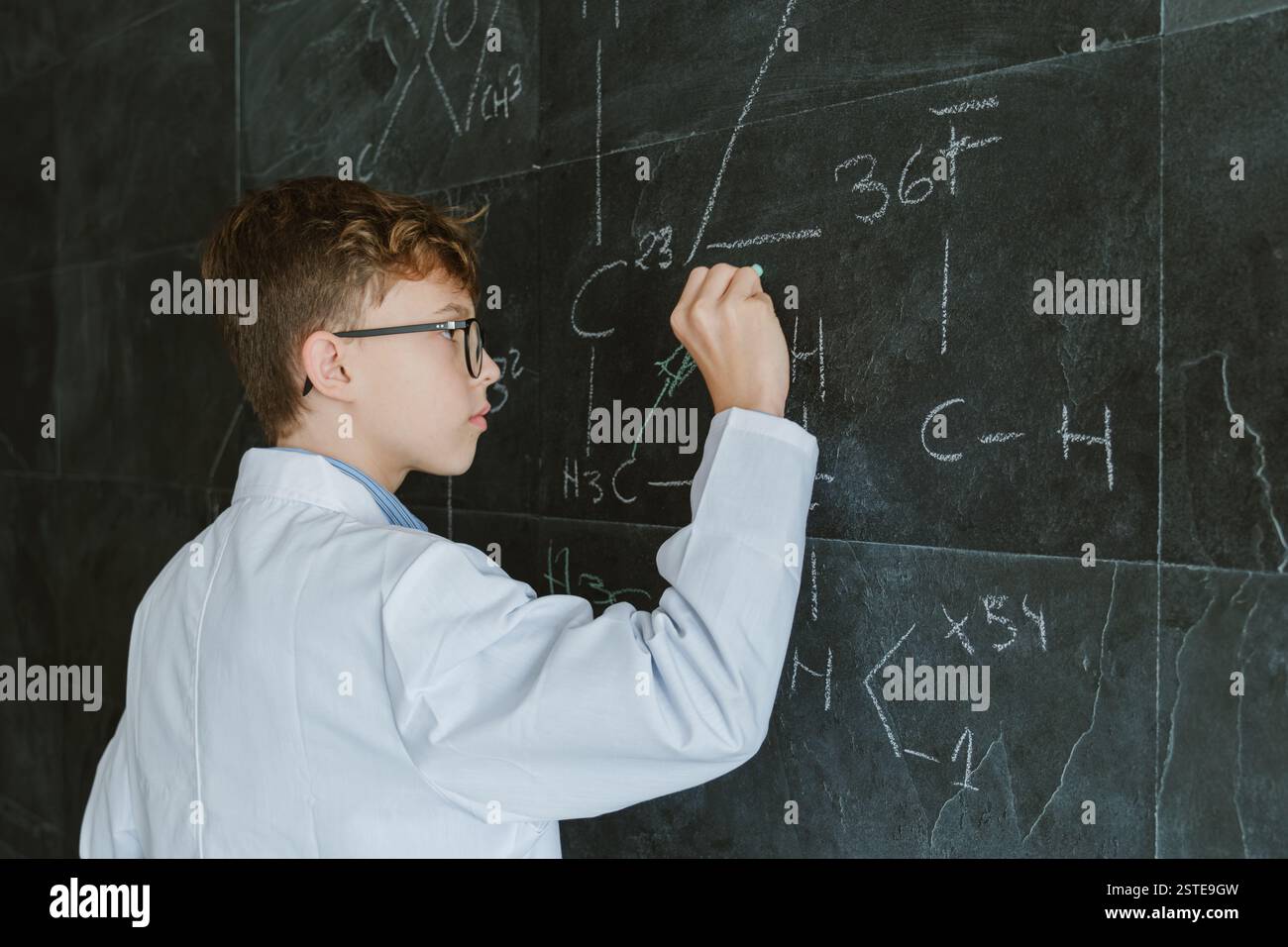 Schoolboy writing chemical formula hi-res stock photography and images ...