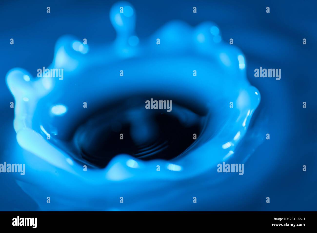 Splash of water crown on blue surface Stock Photo - Alamy