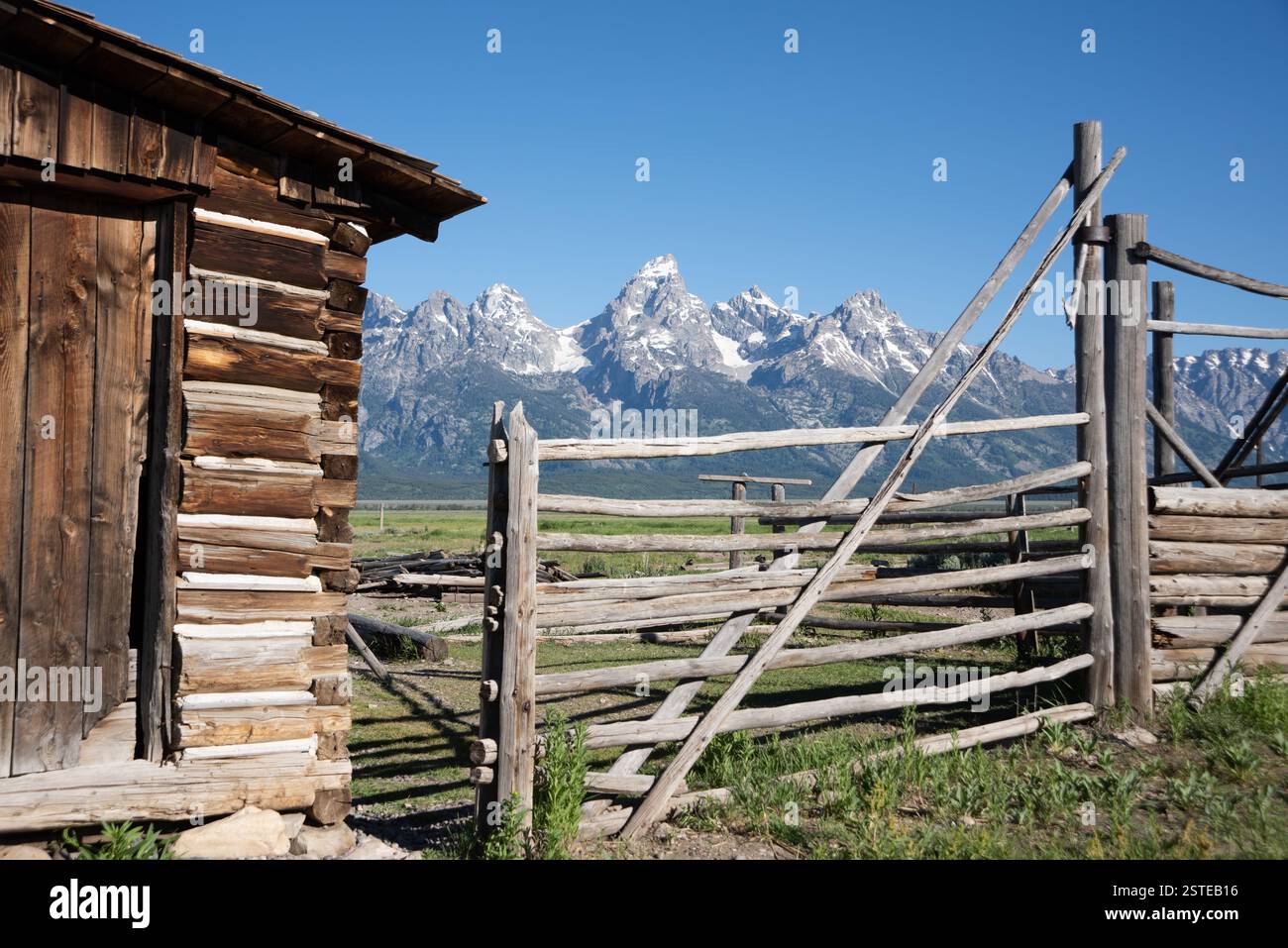 A rustic wooden barn and fence near Jackson Hole, with the Grand Teton ...