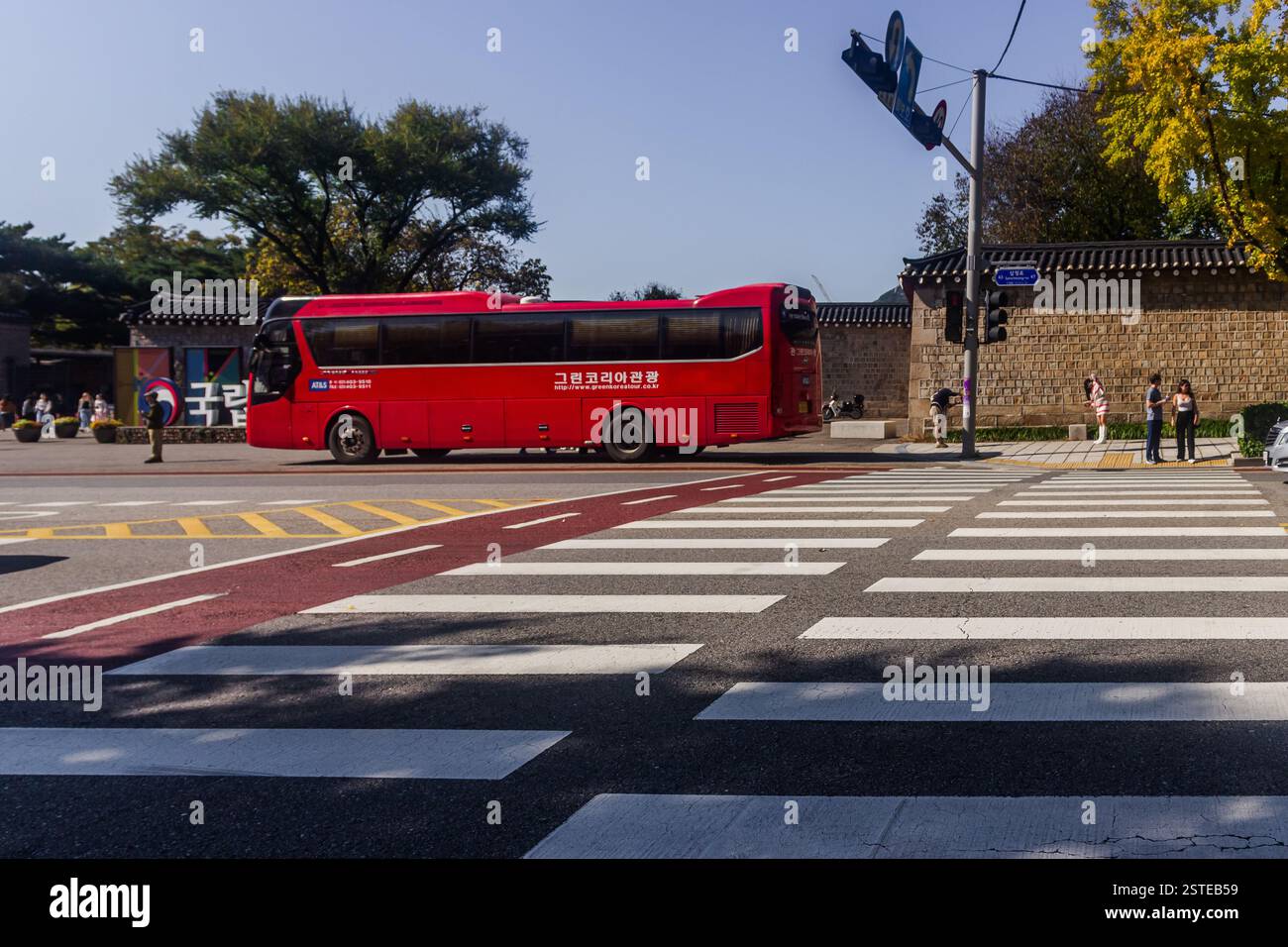 Seoul, South Korea - October 26, 2024: A red bus crossing a pedestrian ...