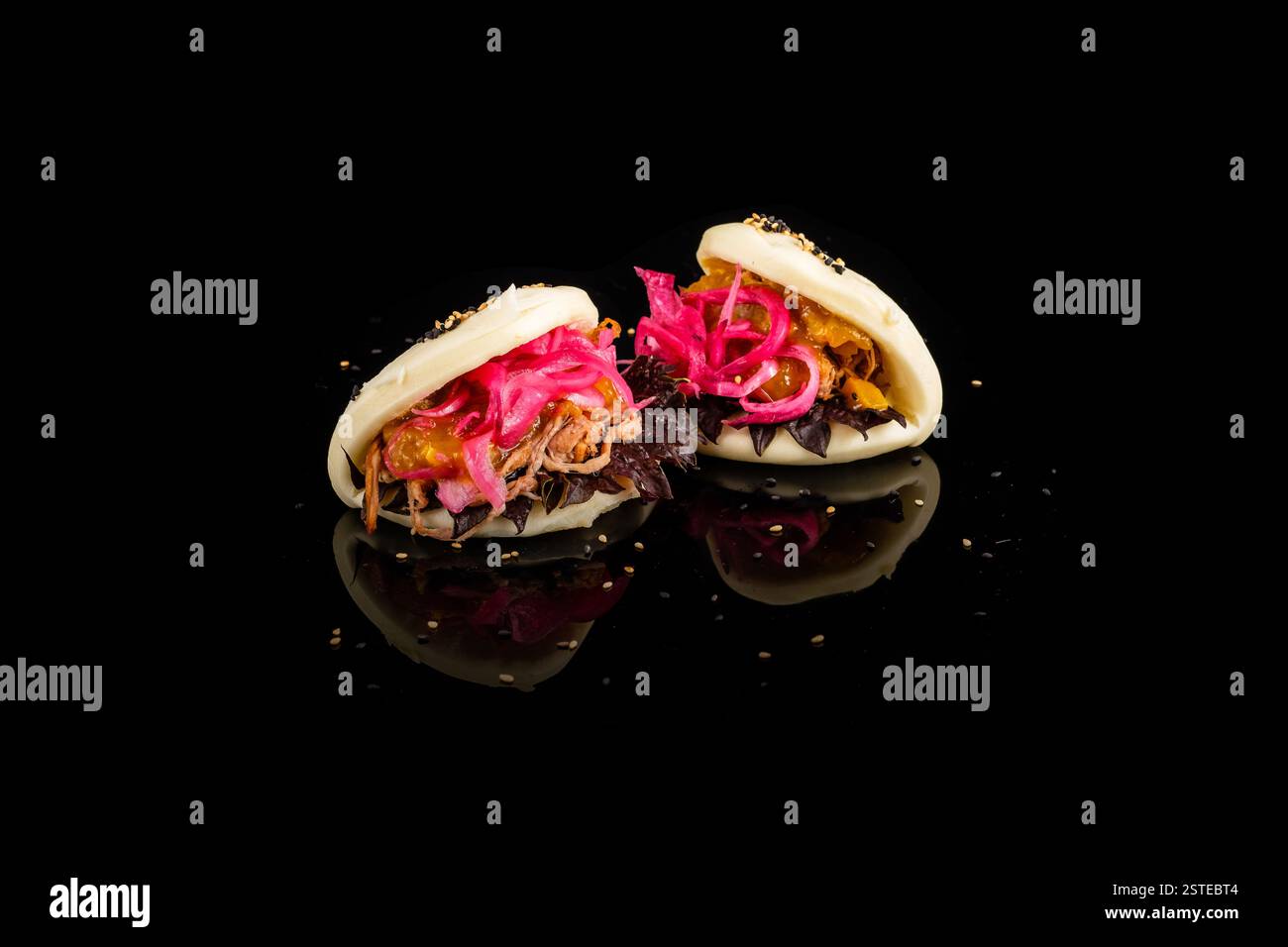 Two Asian bao buns, stuffed with colorful pickled vegetables and ...
