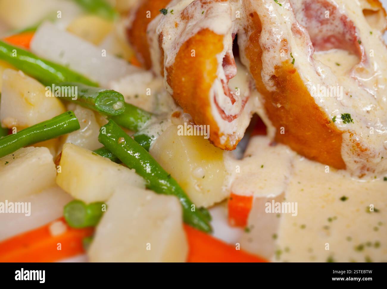 Chicken Cordon Bleu with boiled potatoes and vegetables Stock Photo - Alamy