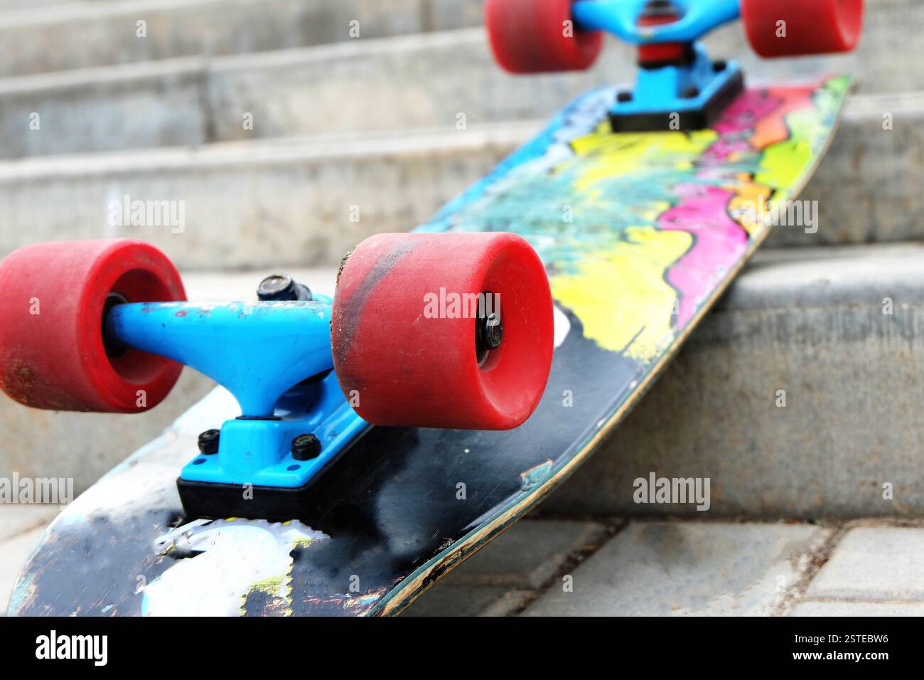 Vintage Style Colorful Skateboard with Red Wheels on a Street Stairs ...