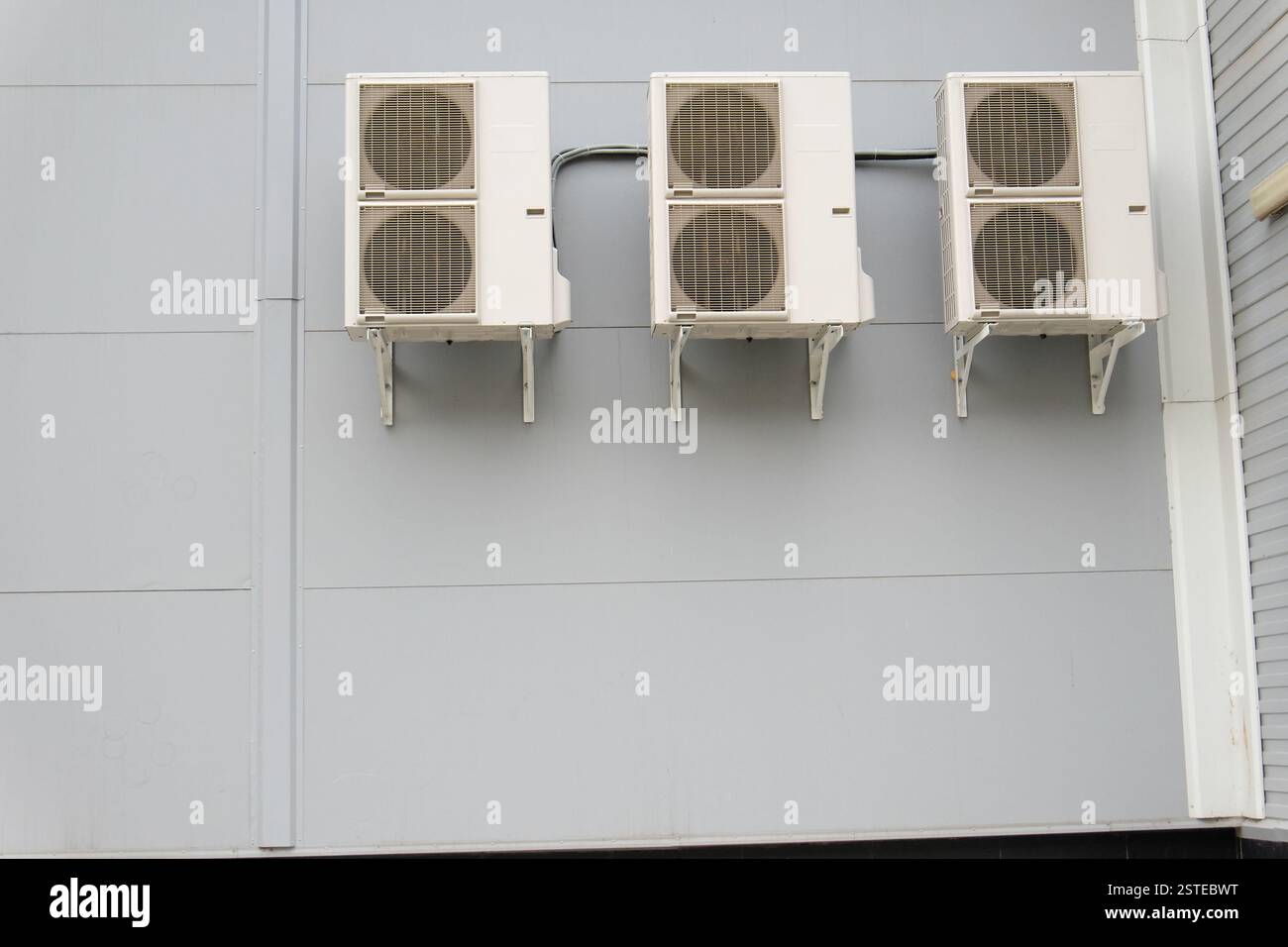 Three split-system on gray wall Stock Photo - Alamy