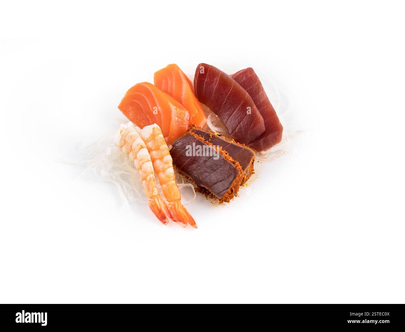 A selection of salmon, tuna and shrimp sashimi, on a bed of grated ...
