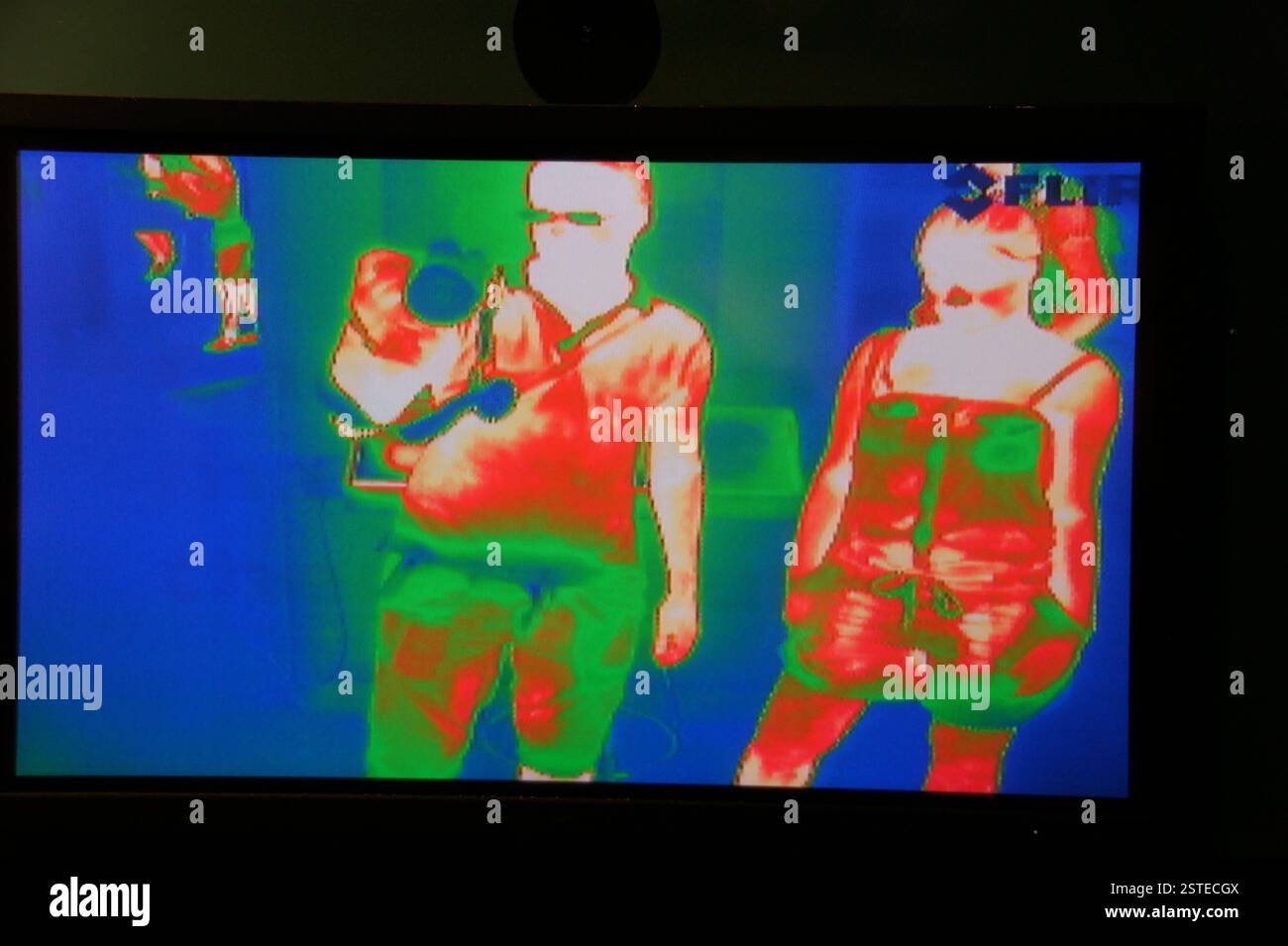 Thermal image of two people standing in Boston. Man in shorts and tank ...