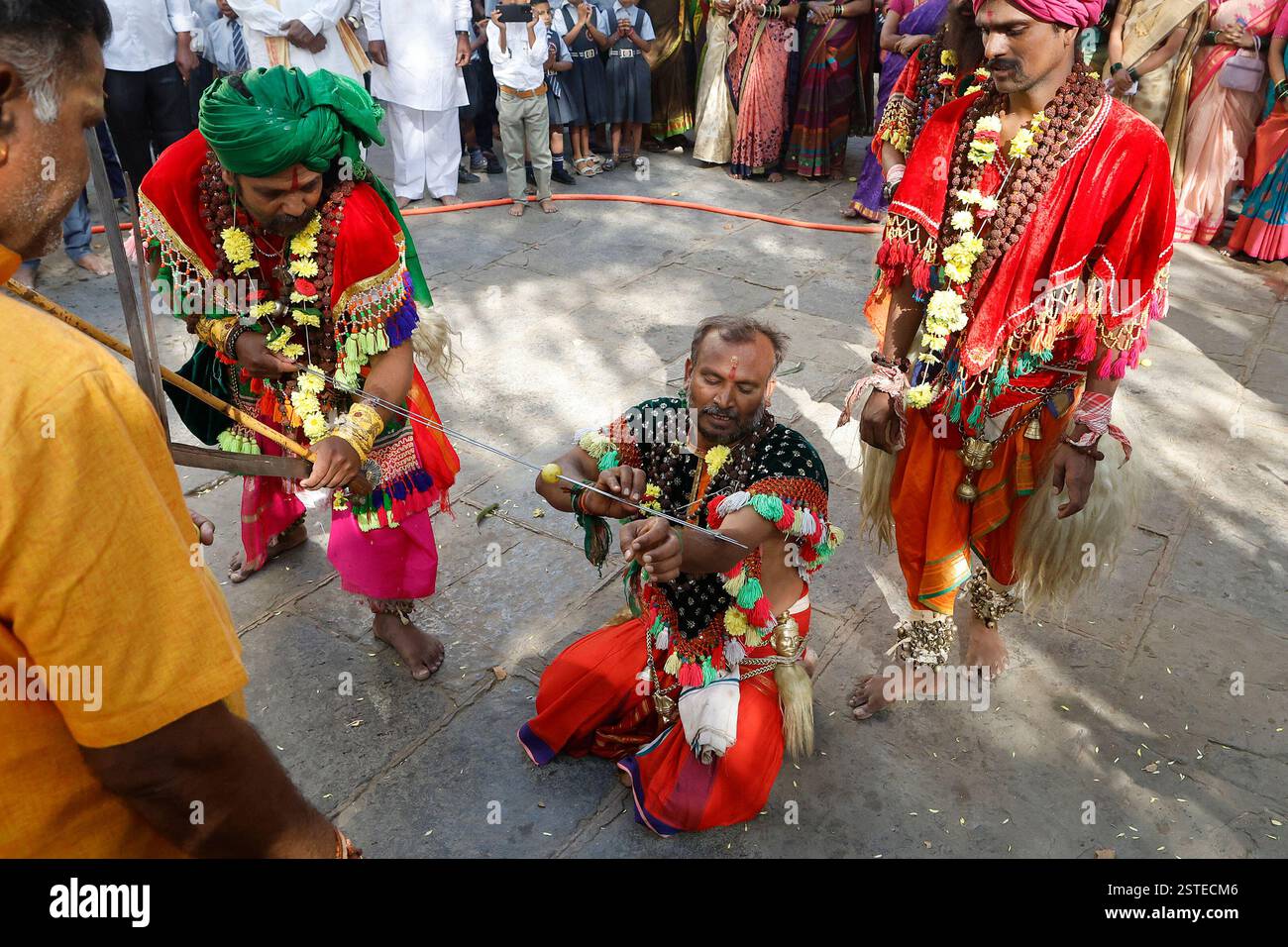 A sword dancer pierces his sking above the wrist at a wedding ceremony ...