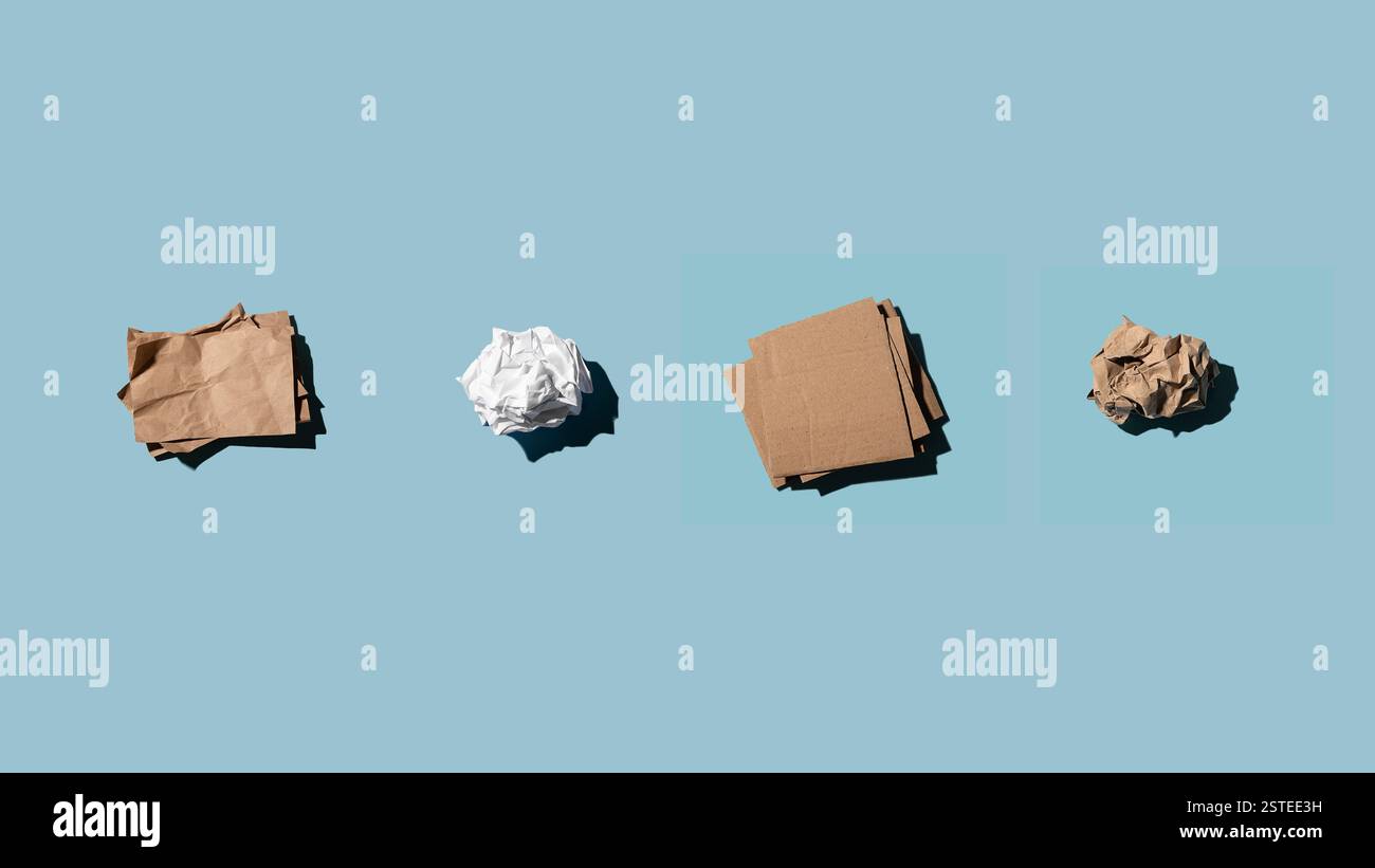 Four different crumpled paper items are laid out on a solid blue ...