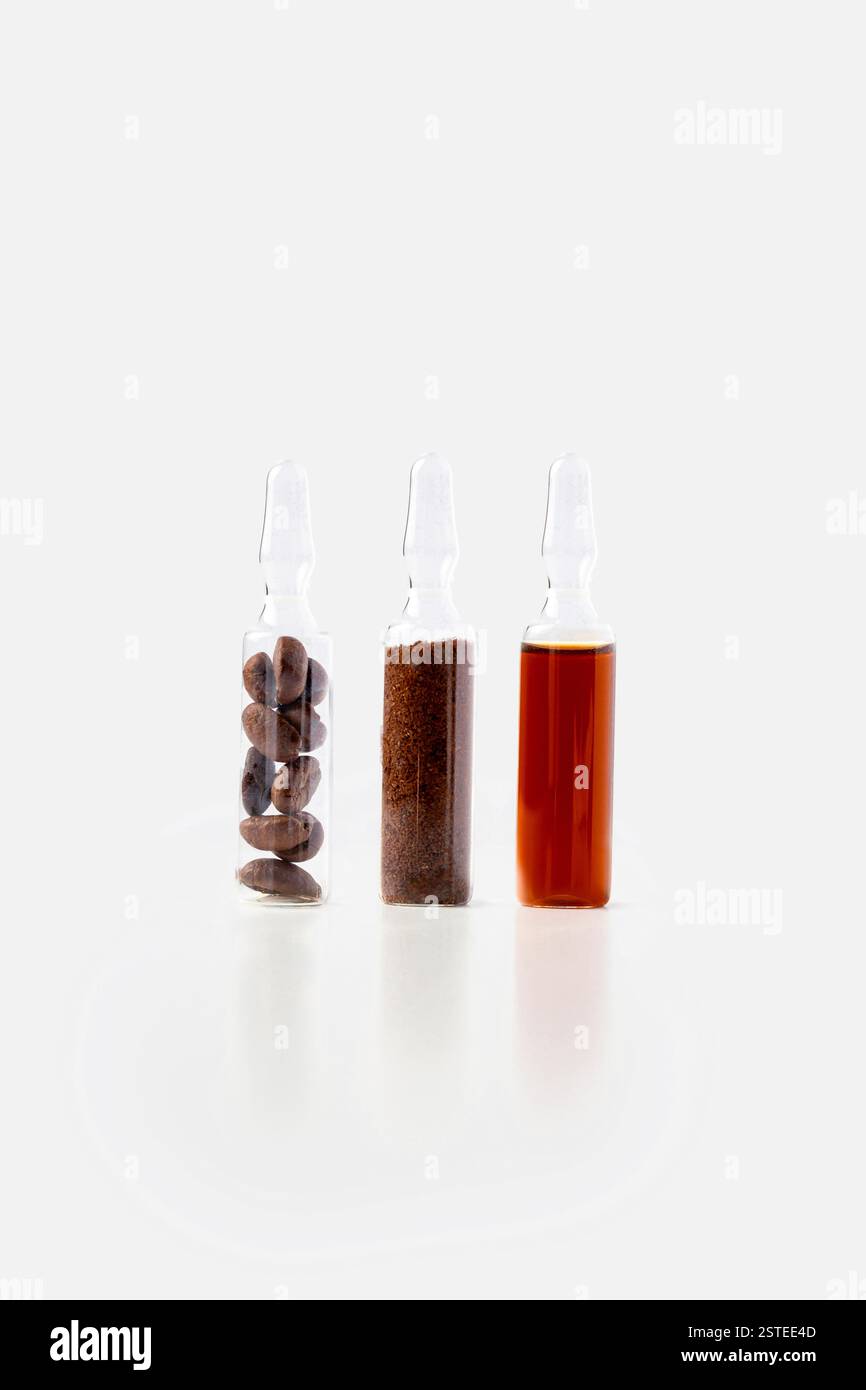 Three small glass vials against a white background, filled with ...