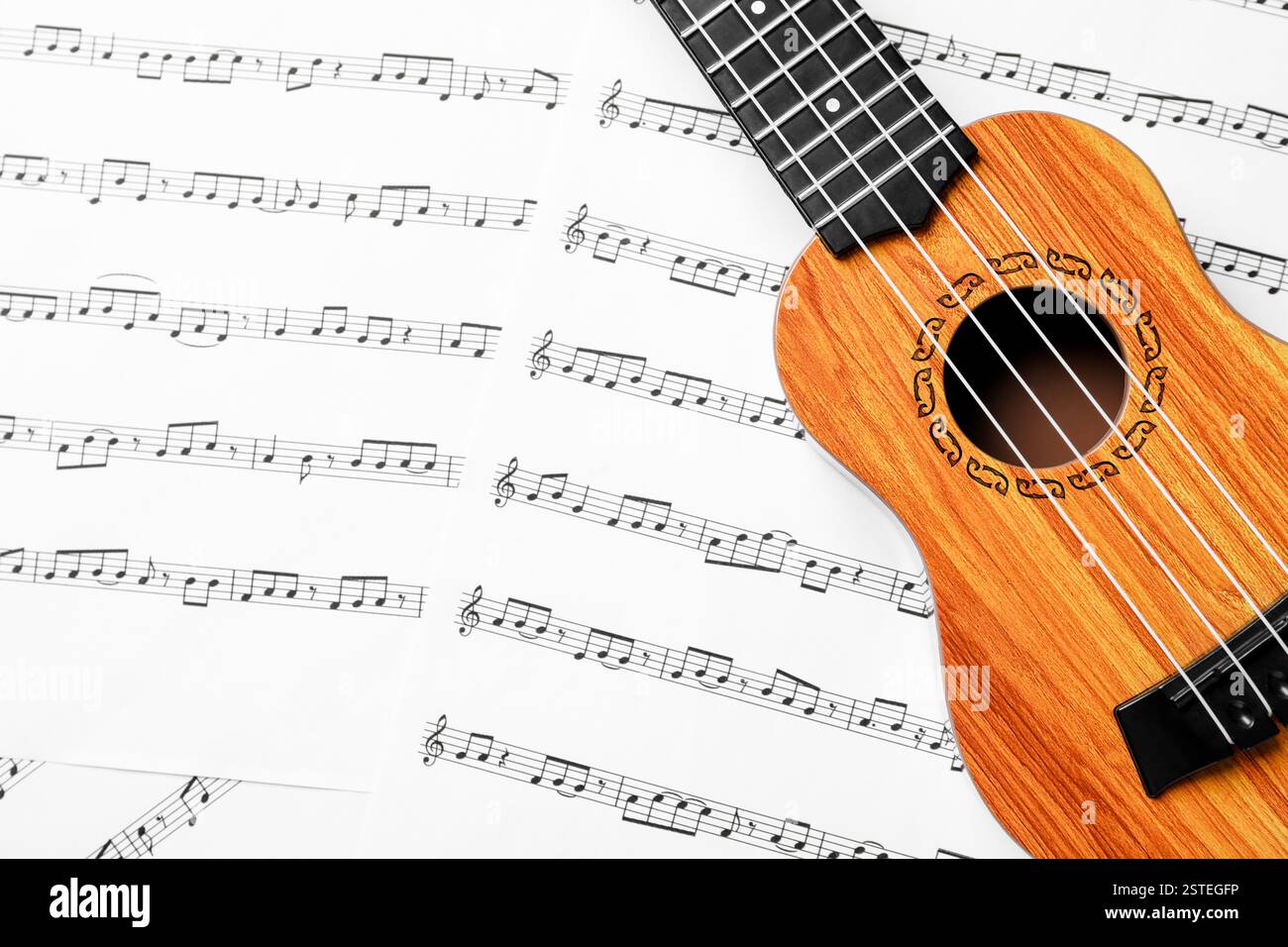 One ukulele on music sheets, top view Stock Photo - Alamy