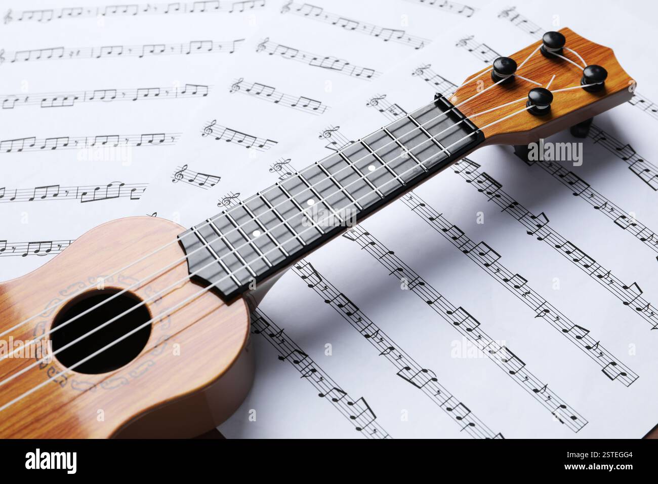 One ukulele on music sheets, closeup view Stock Photo - Alamy