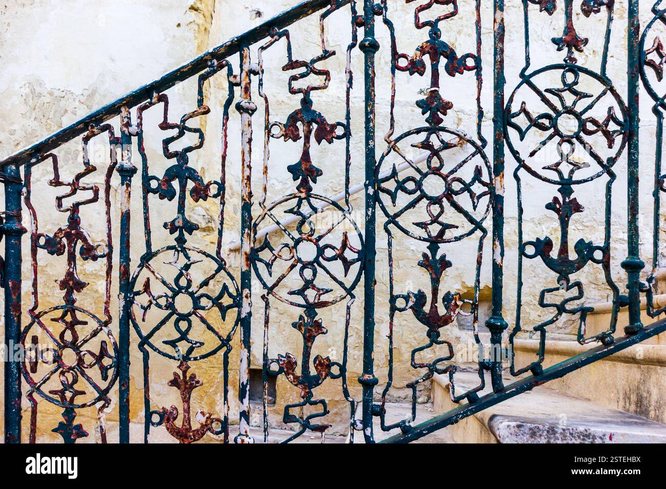 Rustic Wrought Iron Railing with Ornate Patterned Details in an Outdoor ...
