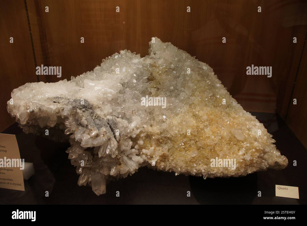 Crystal cluster. Sparkling white quartz crystals cluster together in a ...