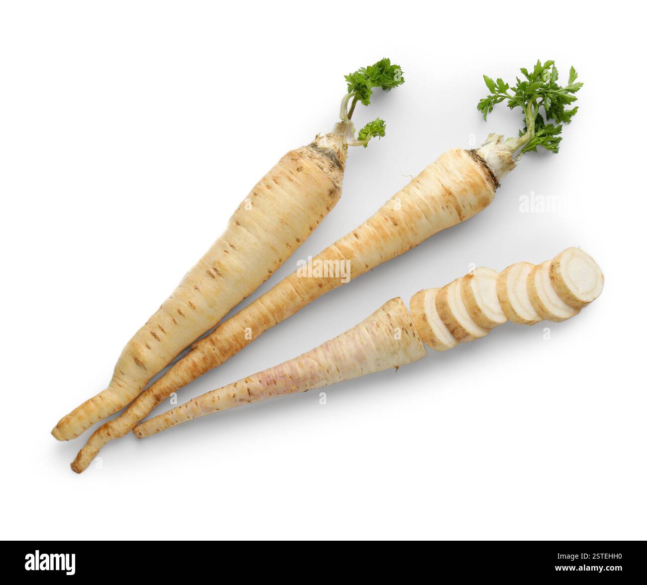 Whole and cut fresh parsley roots isolated on white, top view Stock ...