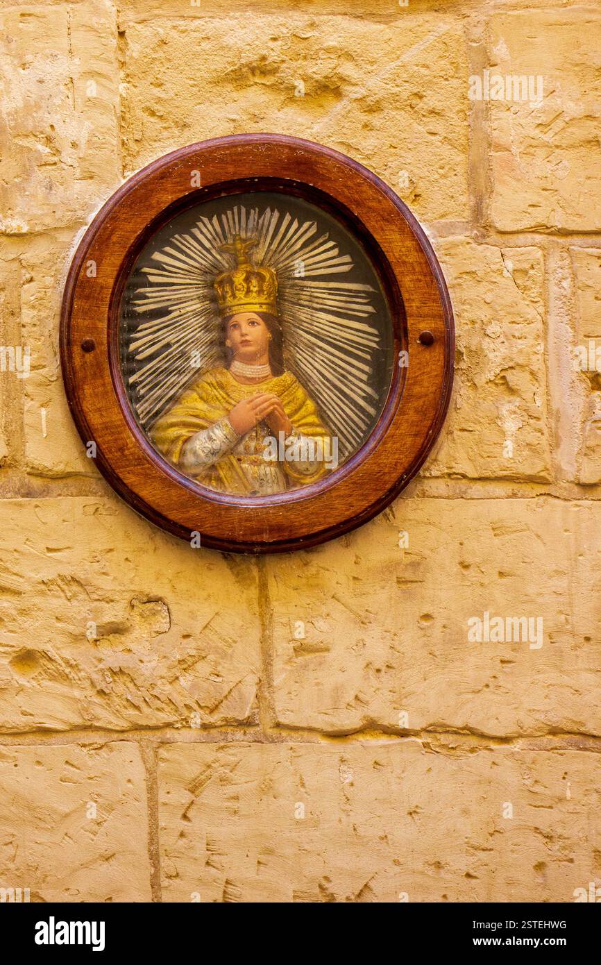 Religious Portrait Framed in Wood Hanging on Textured Stone Wall Stock ...