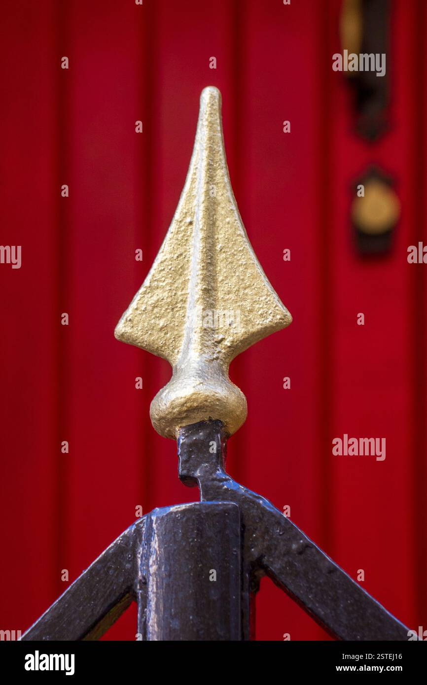 Red Door with Ornamental Metallic Spike Fence in Architectural Setting ...