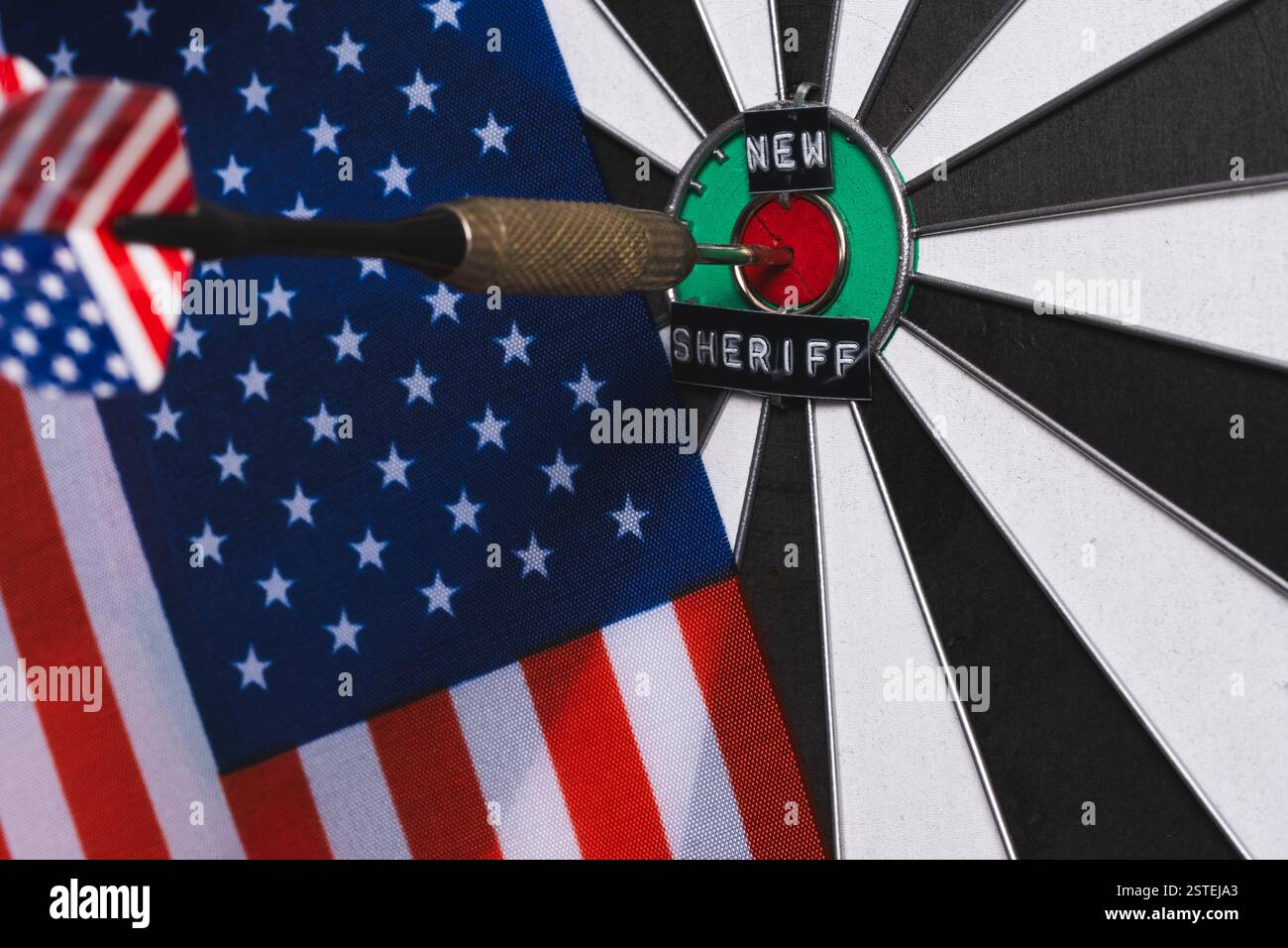 Dartboard with U.S. flag, focus on dart and inscription new sheriff ...