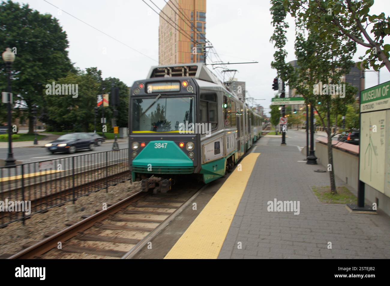 Boston Green Line train at Back Bay Station. The train is green with ...