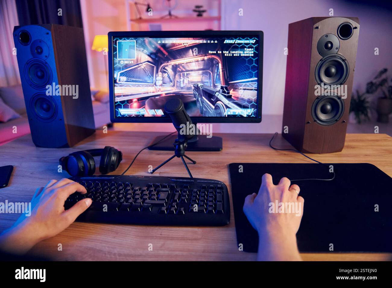 Hands on the mouse and keyboard. Online streamer playing FPS shooter ...