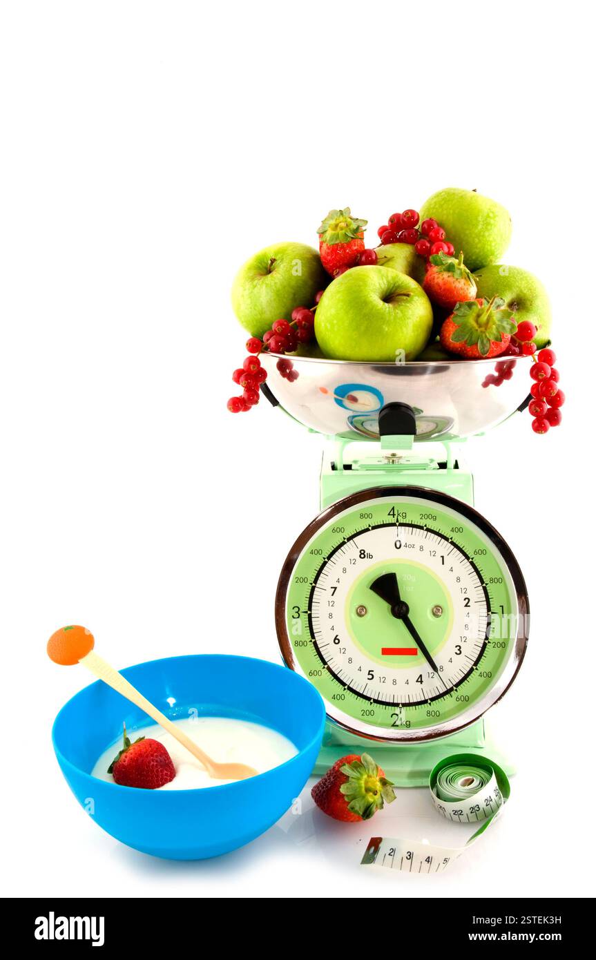 Scale with fruit for diet and yogurt Stock Photo - Alamy