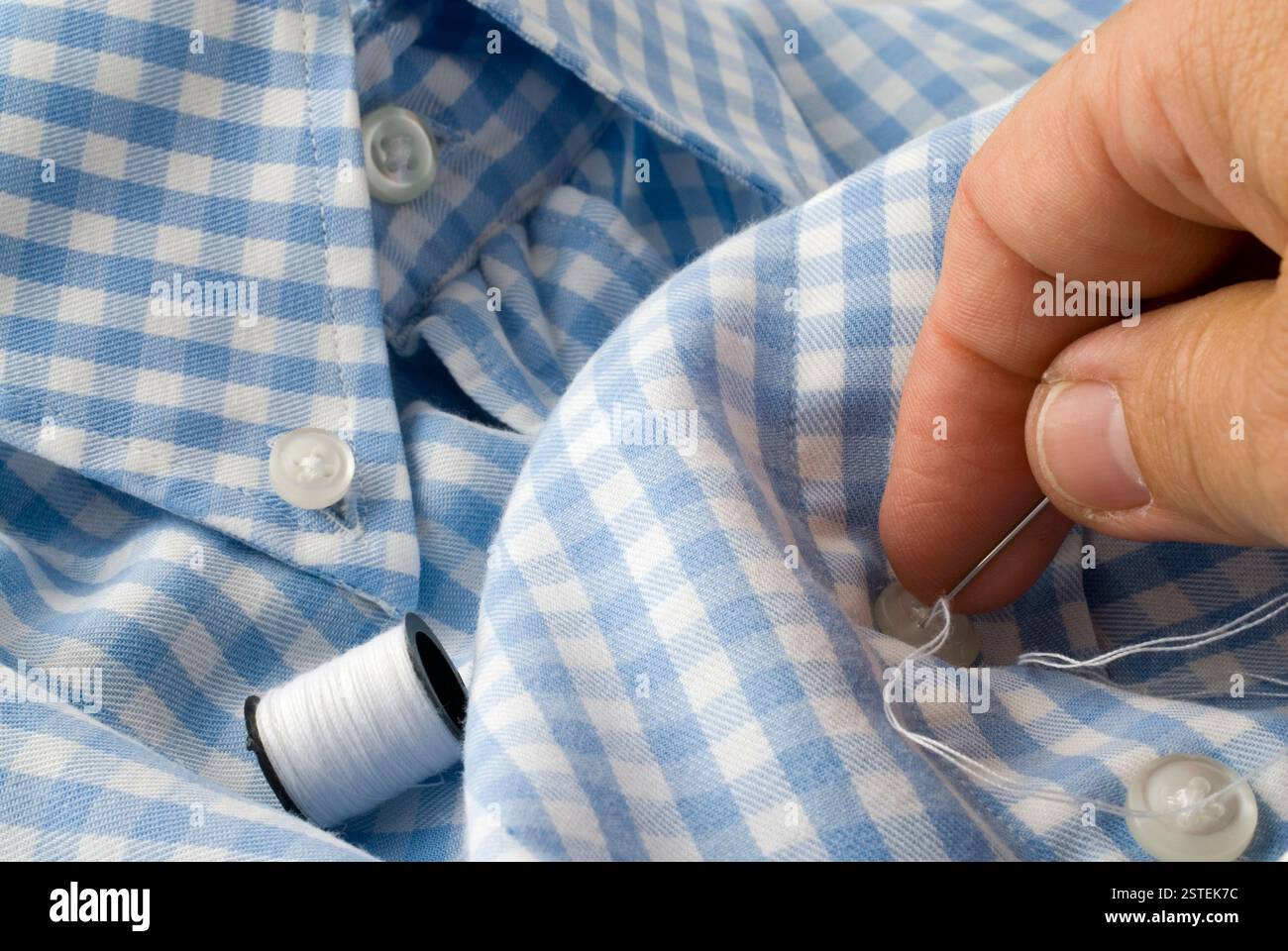 Sew on a button Stock Photo - Alamy