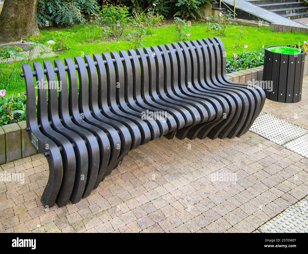Modern park bench made from recycled materials Stock Photo - Alamy