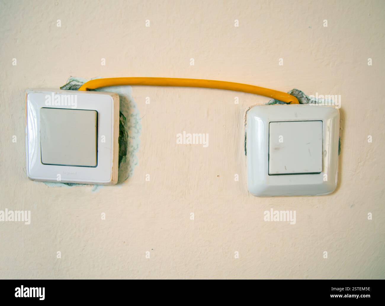 Two light switches connected to each other by a piece of wire Stock ...