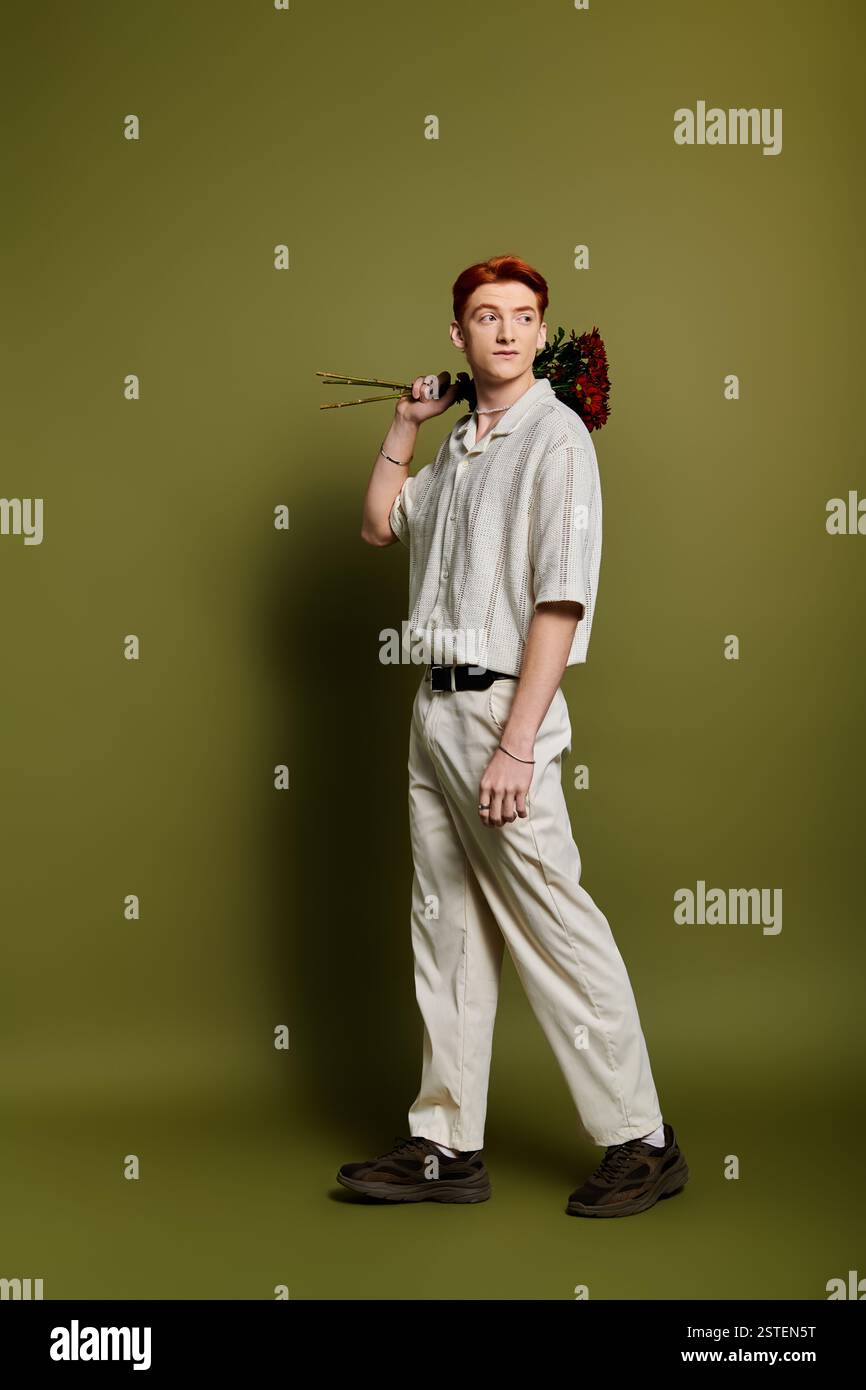 Emotion filled young man stands confidently with flowers on a subtle ...