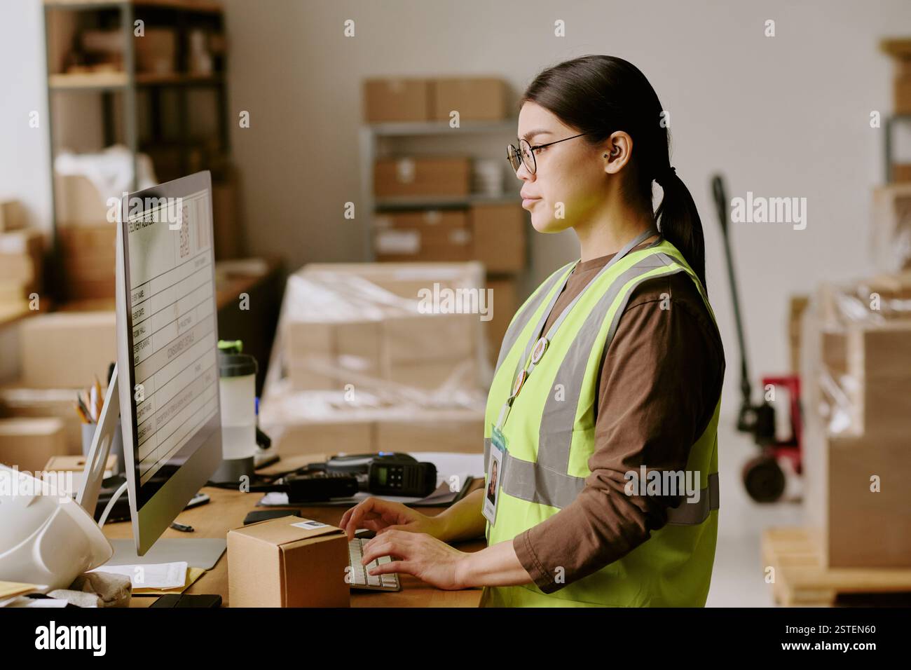 Employee handling package in warehouse, managing inventory using ...