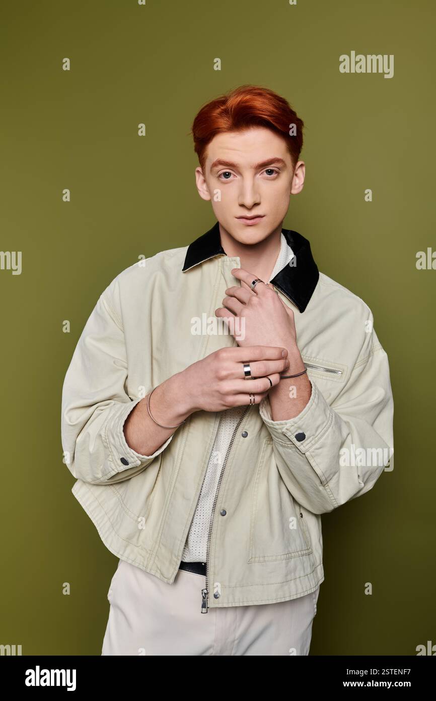 A handsome young man stands with expressive hands, conveying deep ...