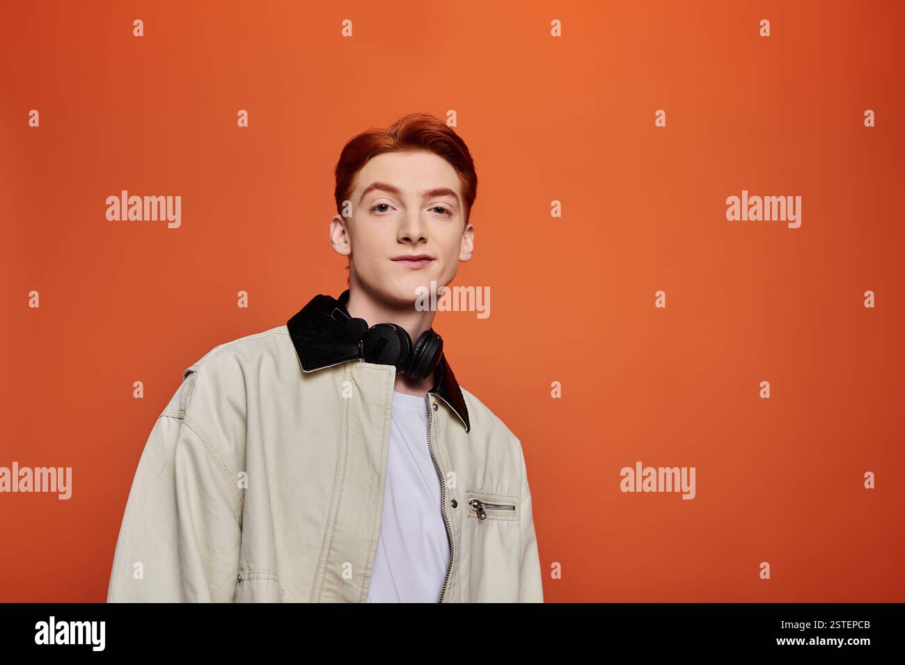 Handsome young man with a charming smile stands confidently, showcasing ...