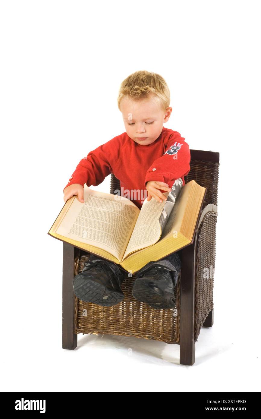 Little boy with heavy book Stock Photo - Alamy