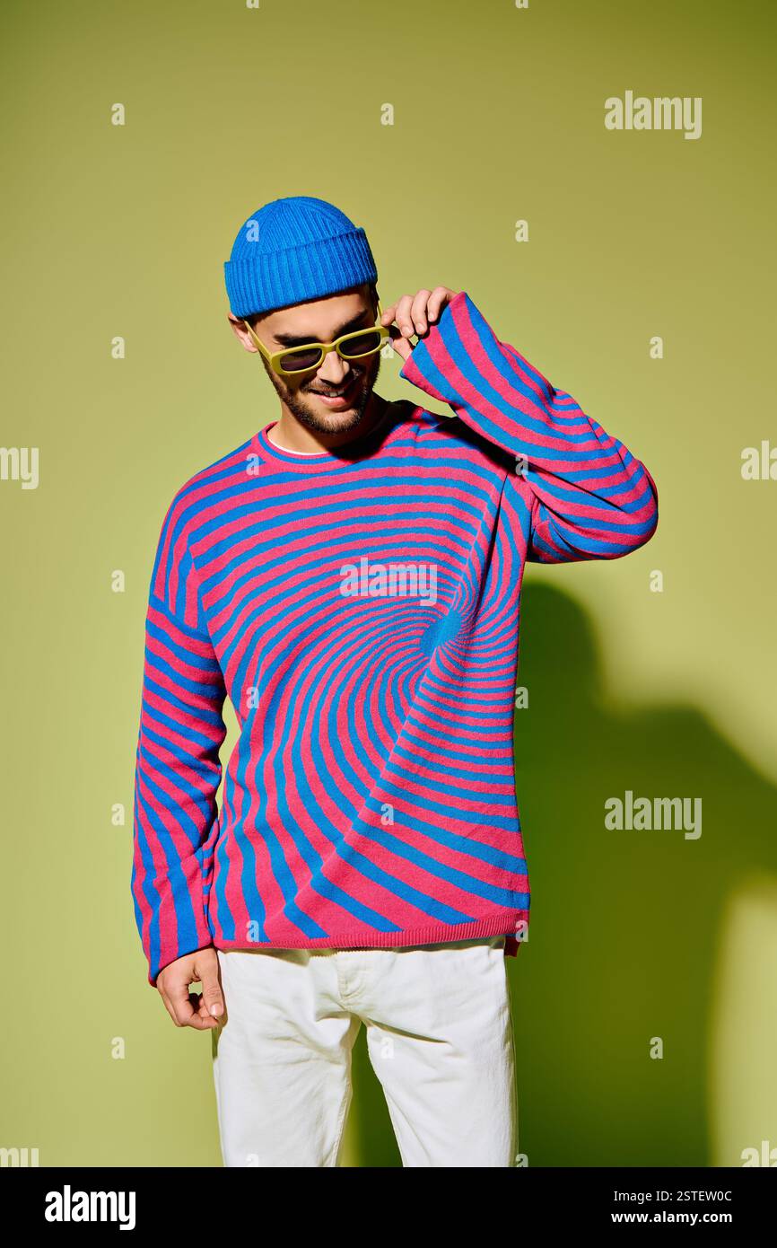 A handsome young man wears a colorful outfit while posing playfully ...
