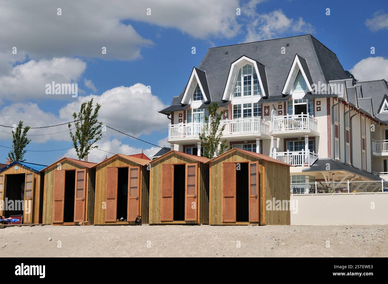 Row of beach huts in front of a big villa Stock Photo - Alamy