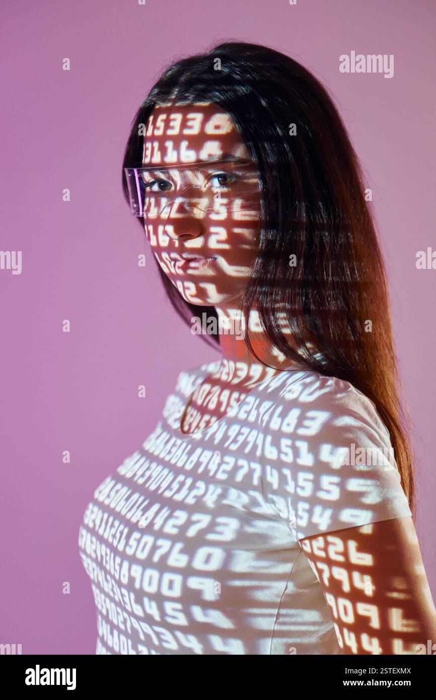 Different numbers. Beautiful young woman is in projector neon lights in ...