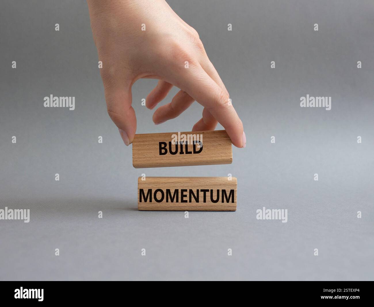 Build momentum symbol. Wooden blocks with words Build momentum ...