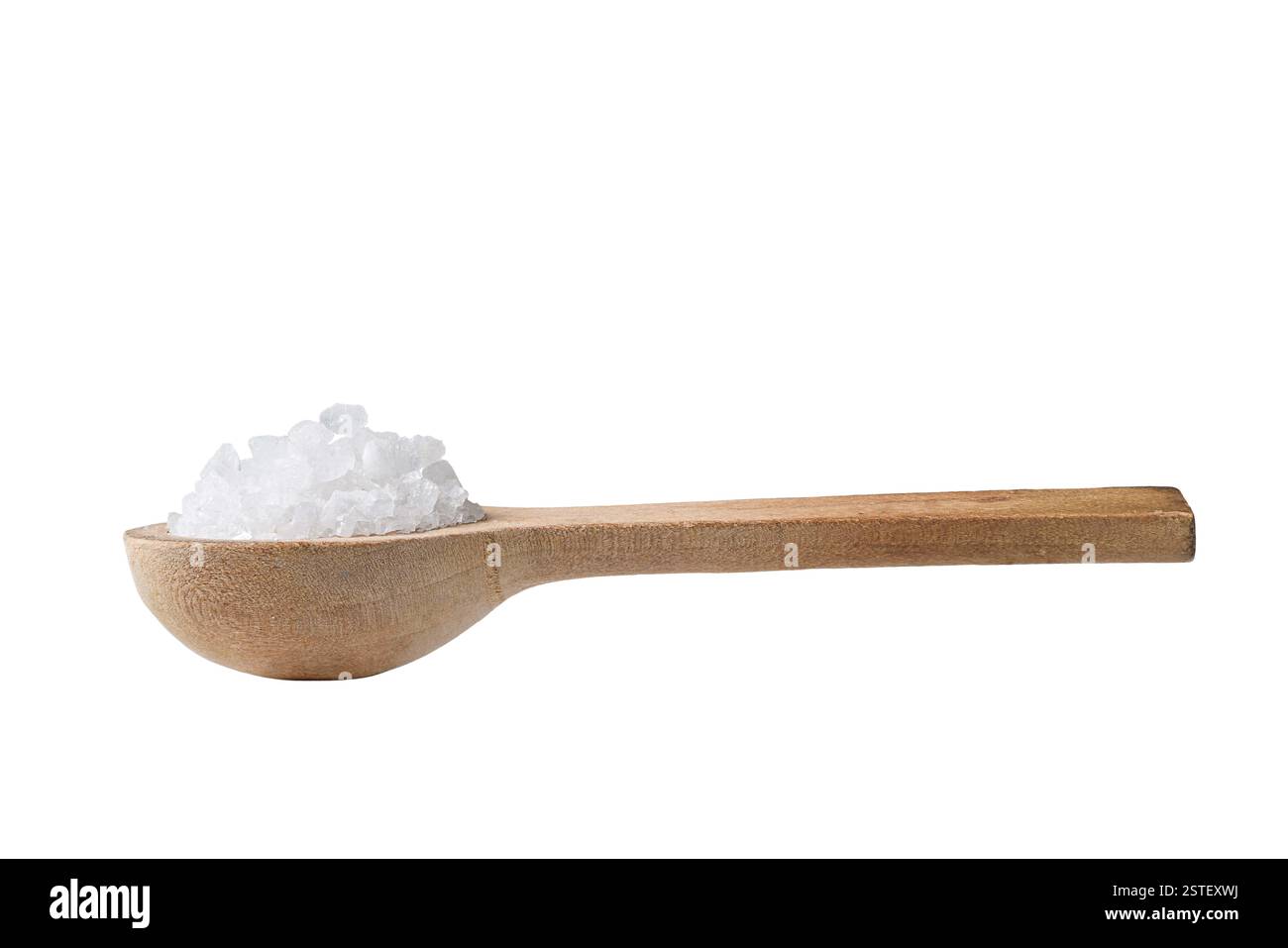 Closeup macro side view heap of coarse sea salt in a wooden spoon ...