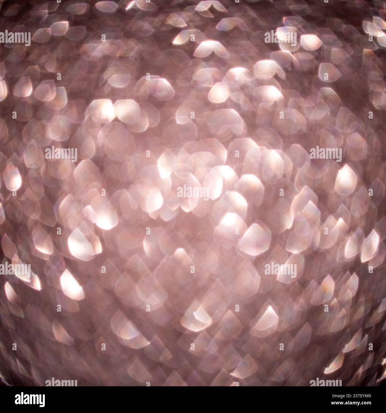 Abstract light bokeh creating a shimmering texture in soft beige tones ...