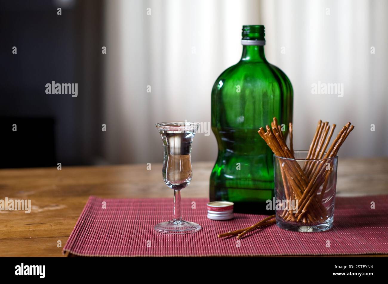 Typical Dutch drink jenever with salted sticks Stock Photo - Alamy