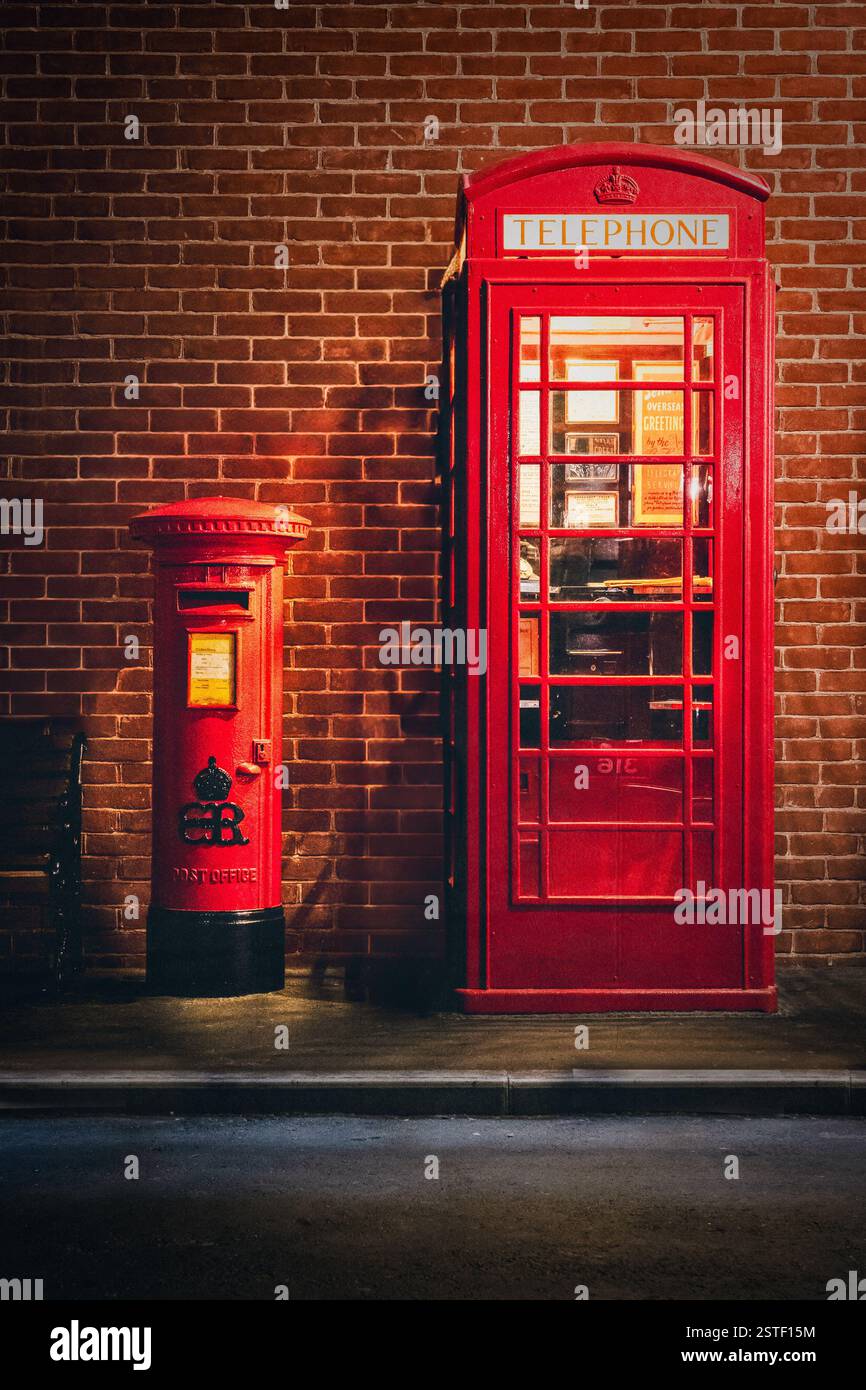 1940's British iconic red telephone box and post box on a street Stock ...