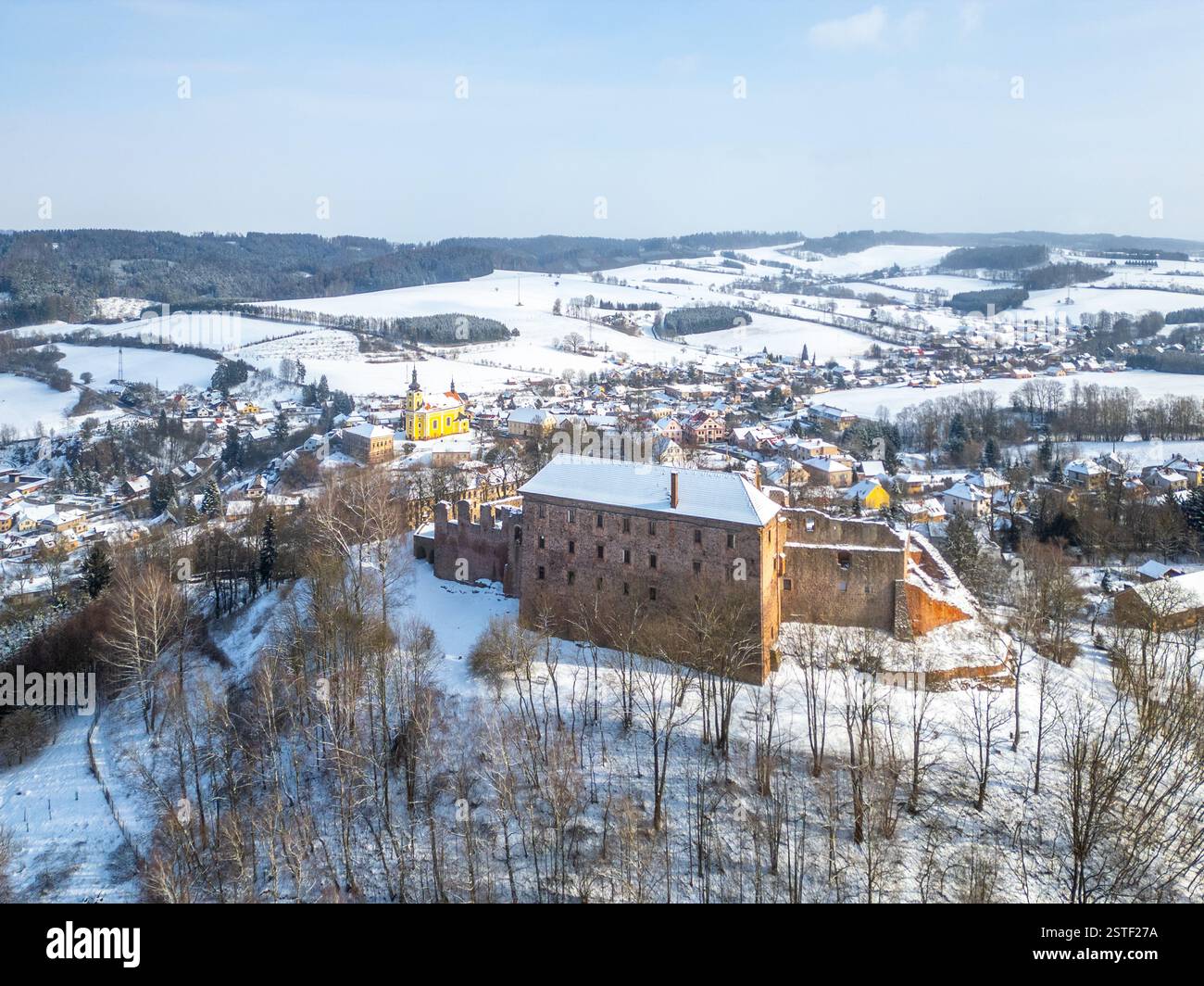 Pecka Castle stands majestically under a blanket of snow during winter ...