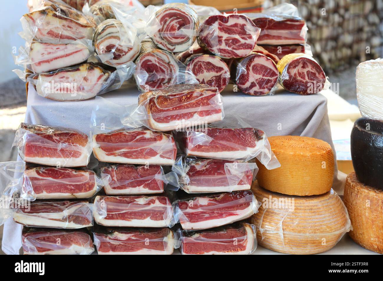 many vacuum-packed cold cuts and cheeses are on sale at the stall of ...