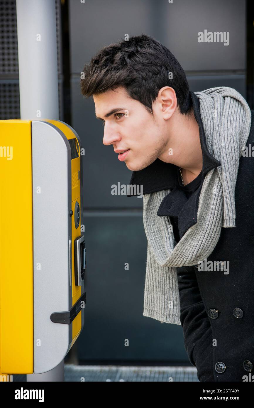 Man bending down peering inside a door Stock Photo - Alamy