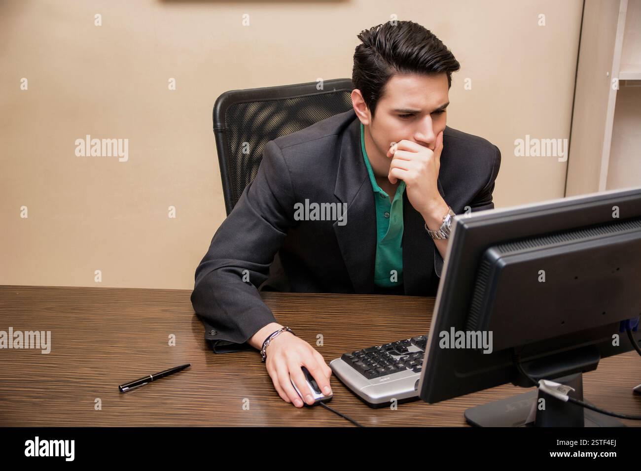 Attractive young confident businessman sitting hi-res stock photography ...
