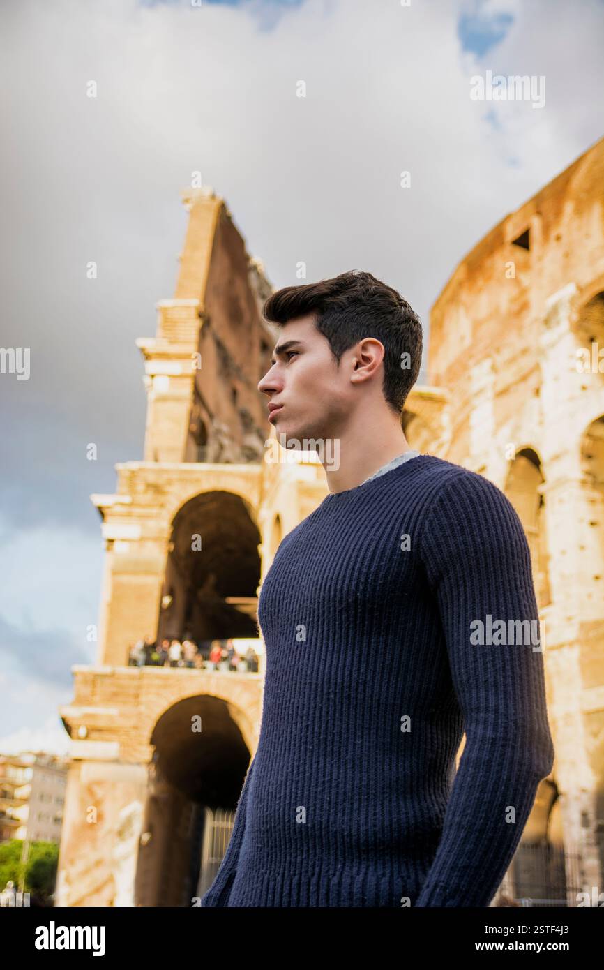 Attractive young man in Rome standing in front of the Colosseum Stock ...
